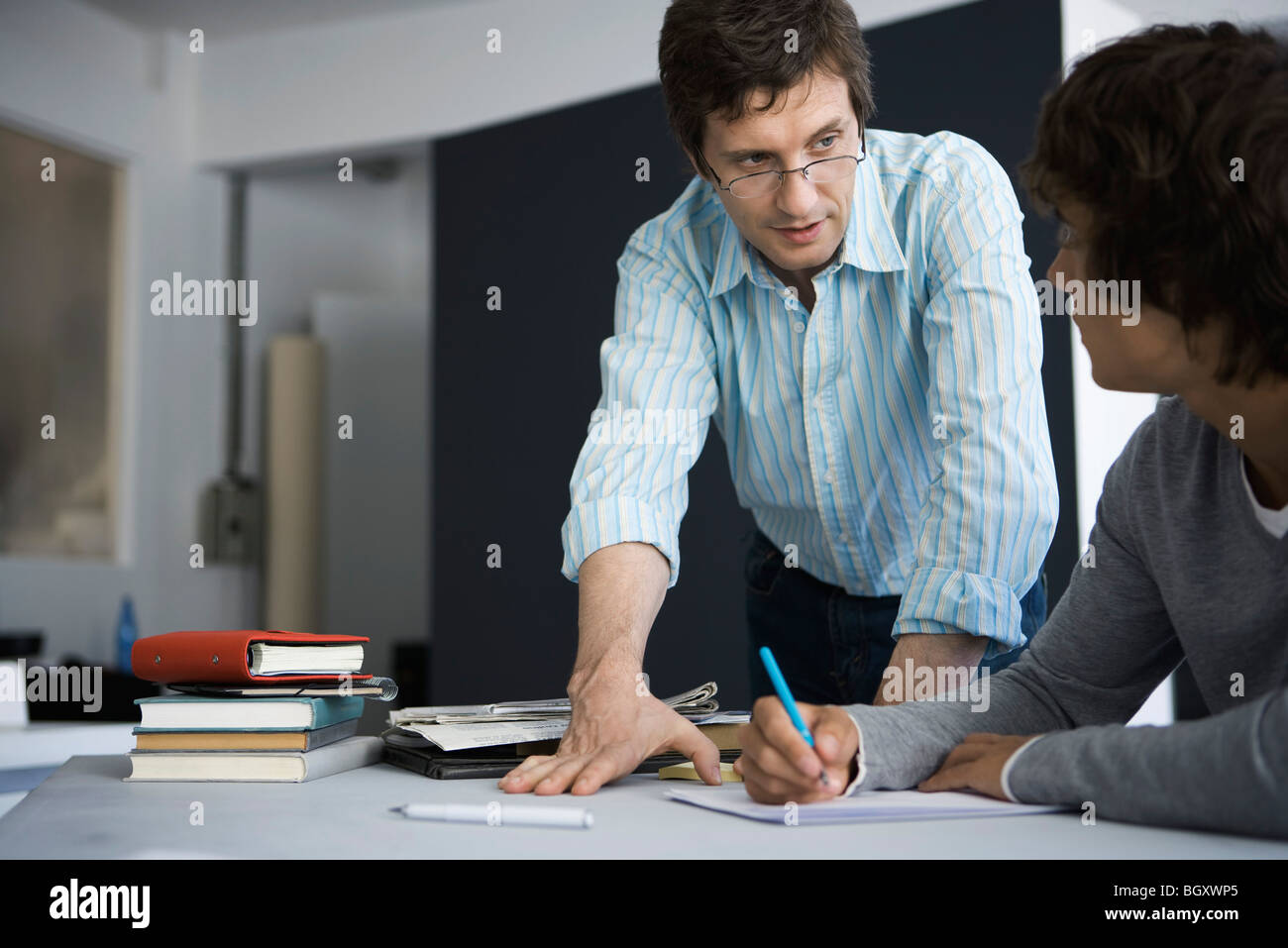 Teacher explaining assignment to student Stock Photo - Alamy