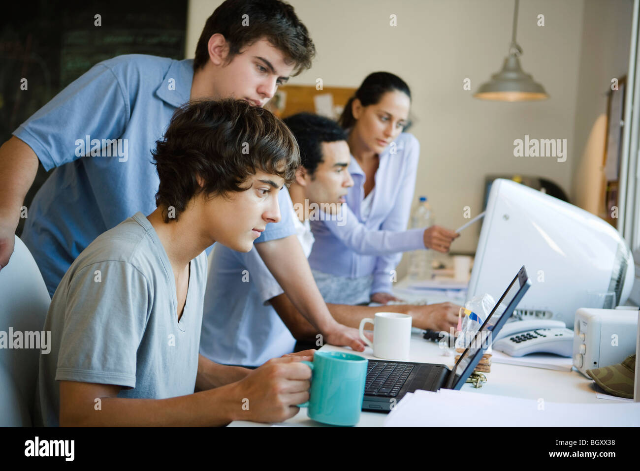 College students collaborating together using computers Stock Photo - Alamy