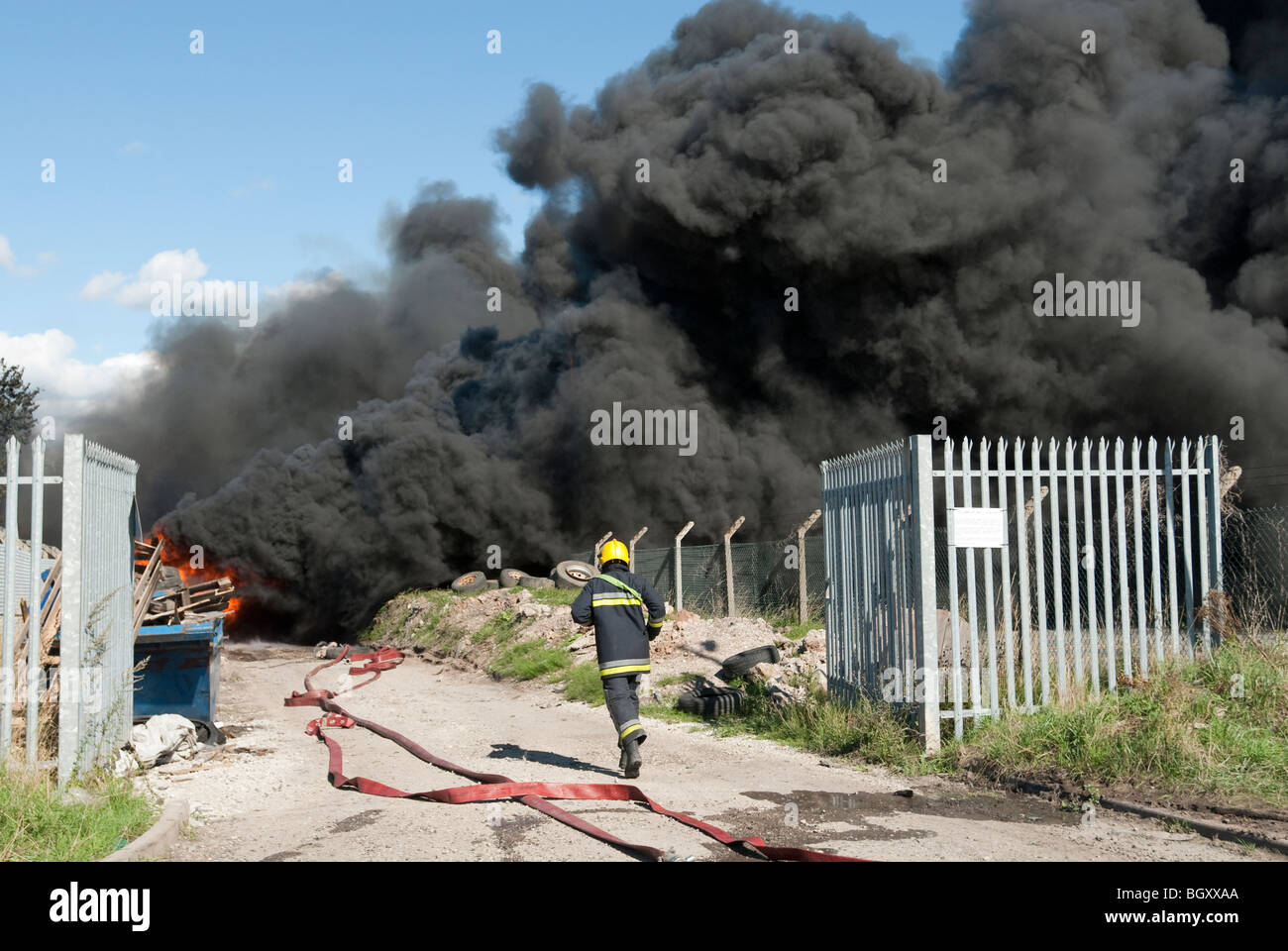 Huge industrial fire with large plumes of thick black smoke against ...