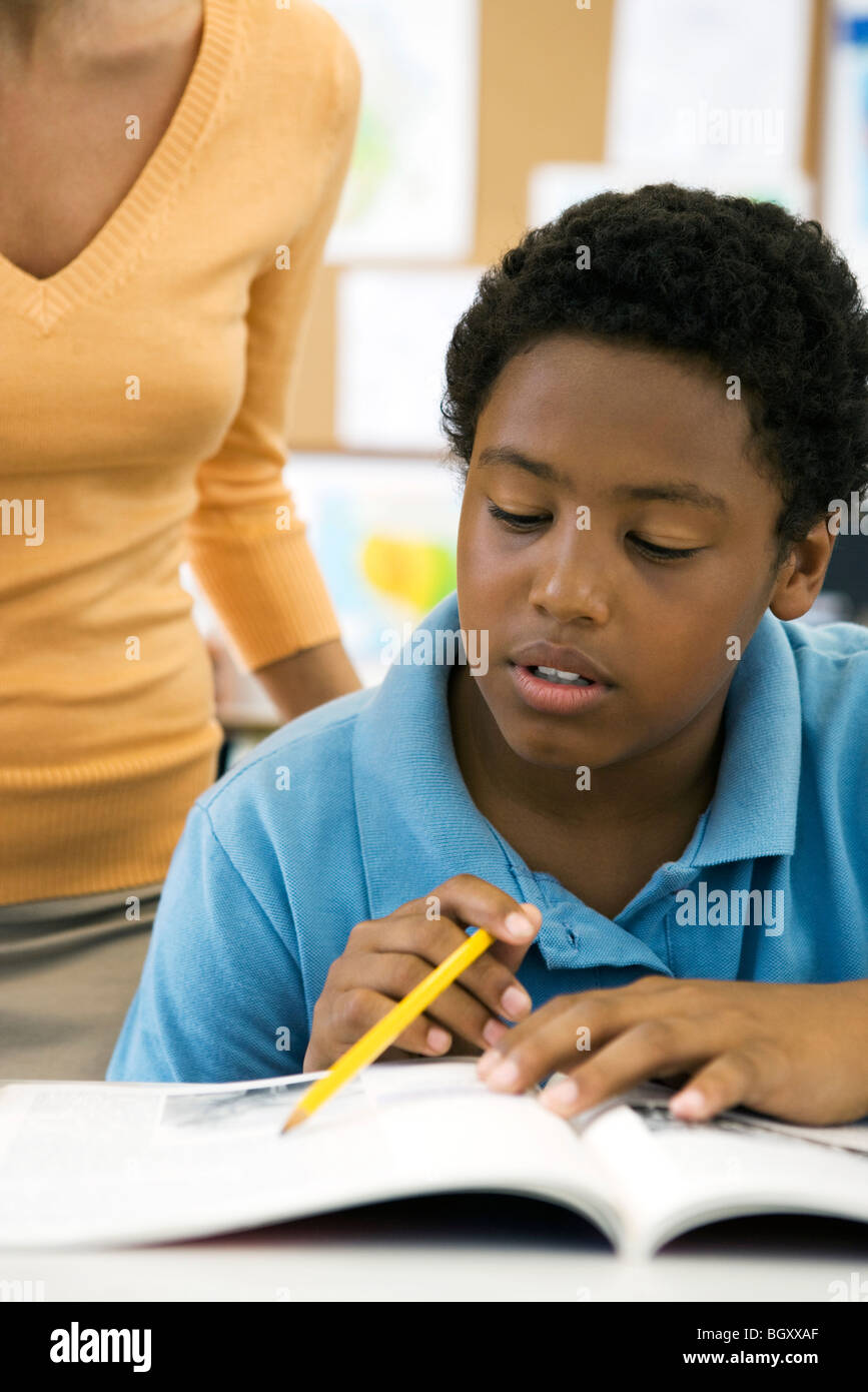 Boy standing front class reading hi-res stock photography and images ...