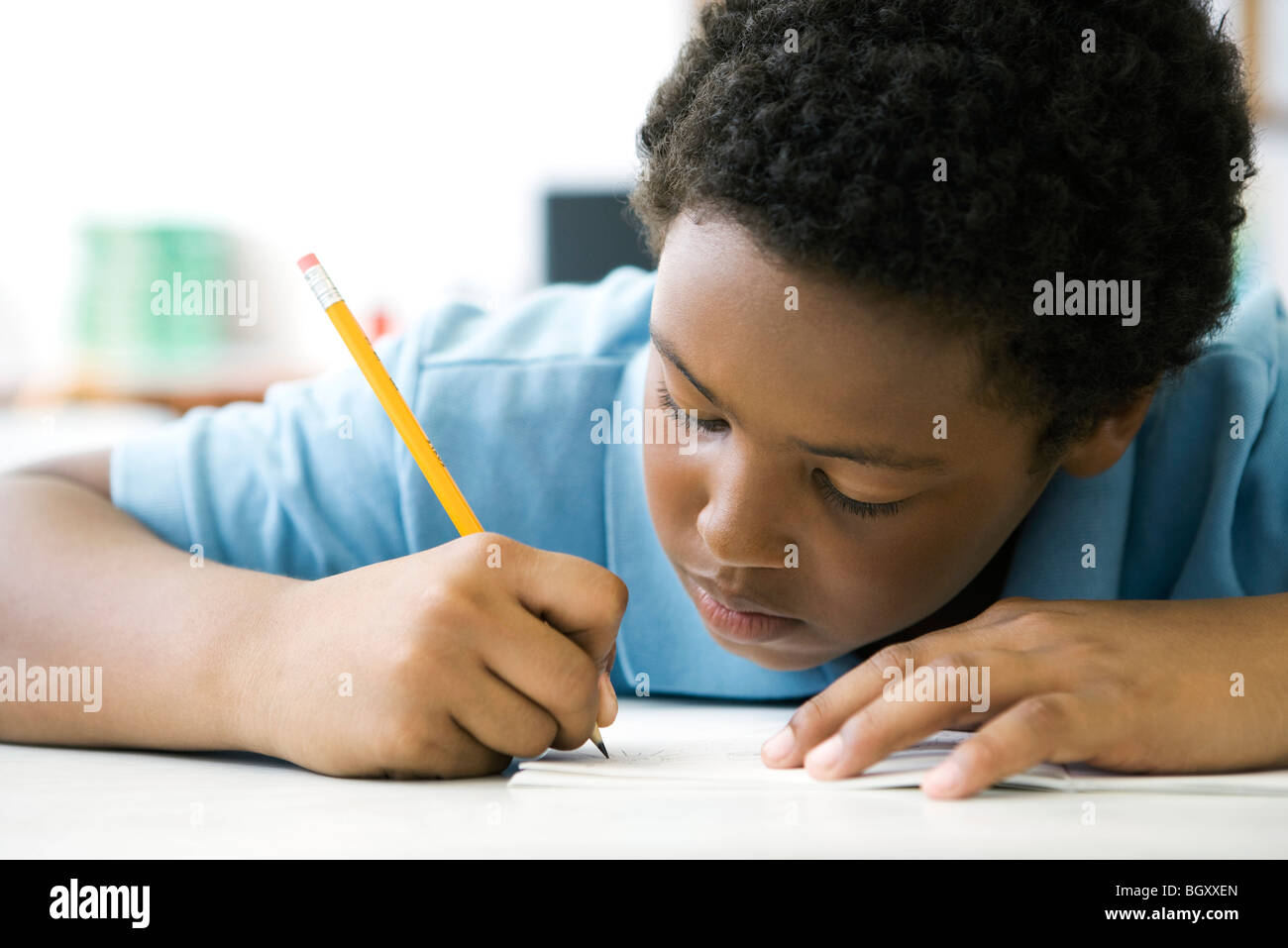 Male elementary school student concentrating on classwork Stock Photo ...
