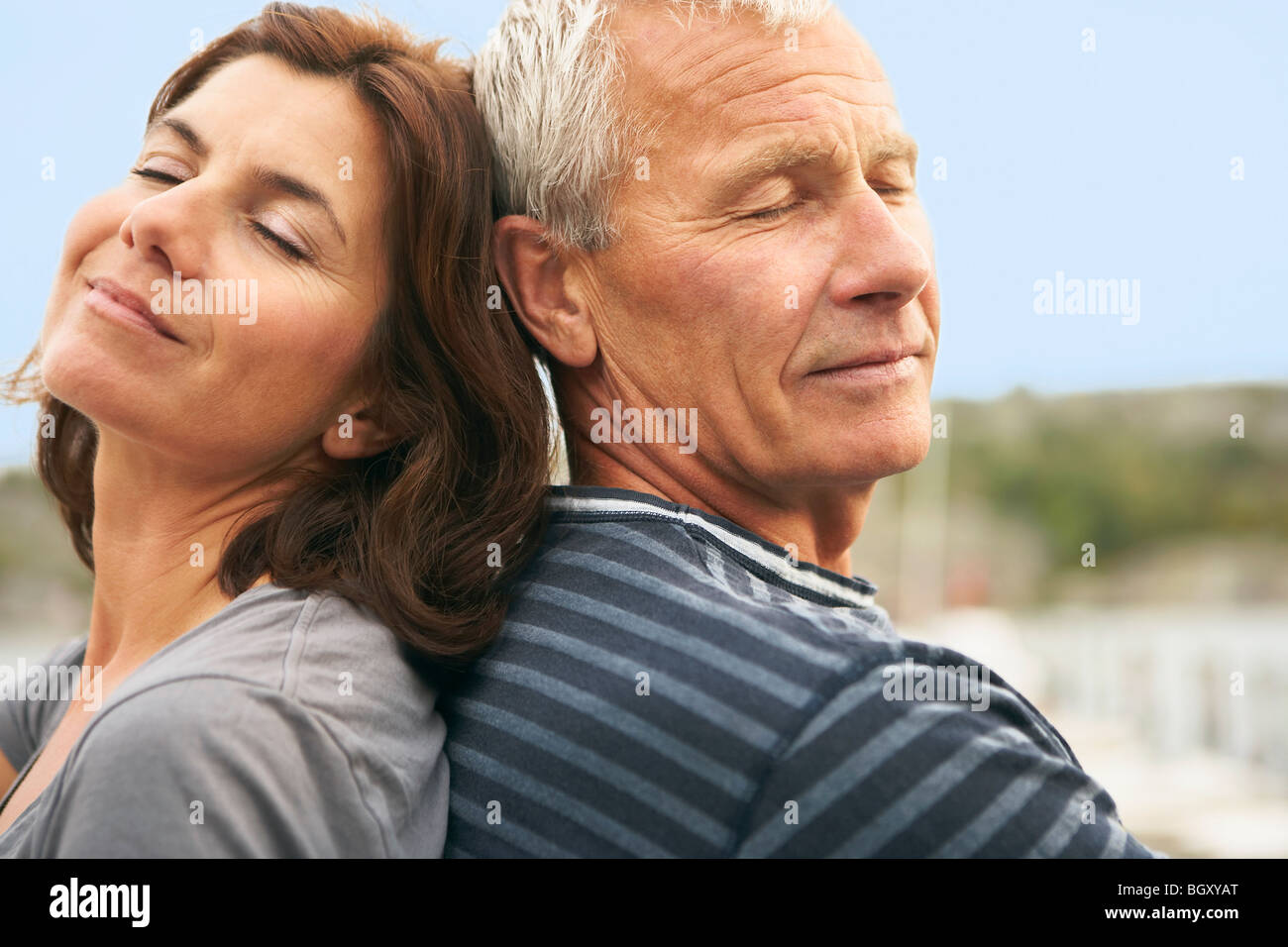 Middle aged couple, back to back Stock Photo - Alamy