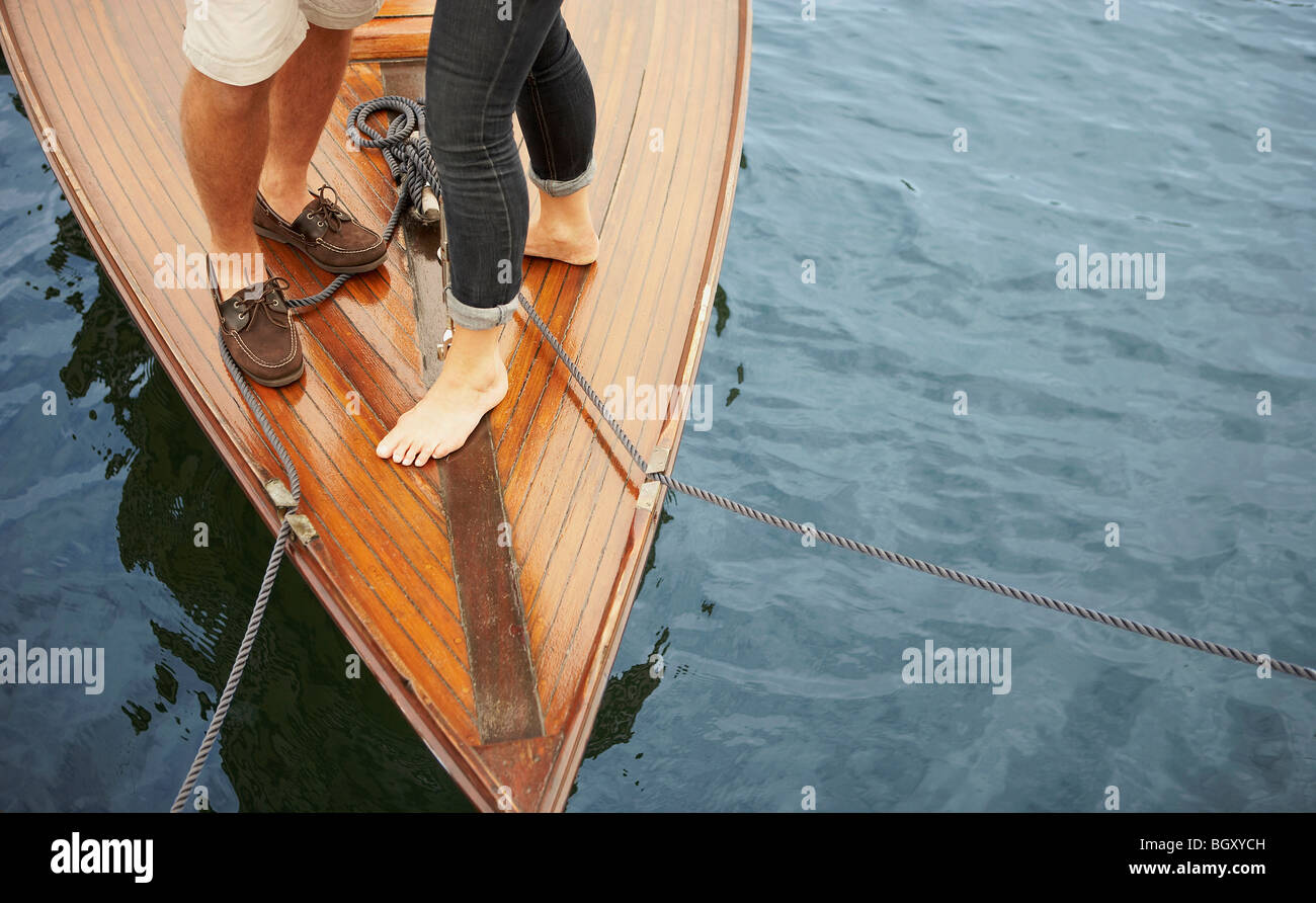 Feet of middle aged couple on old boat Stock Photo - Alamy