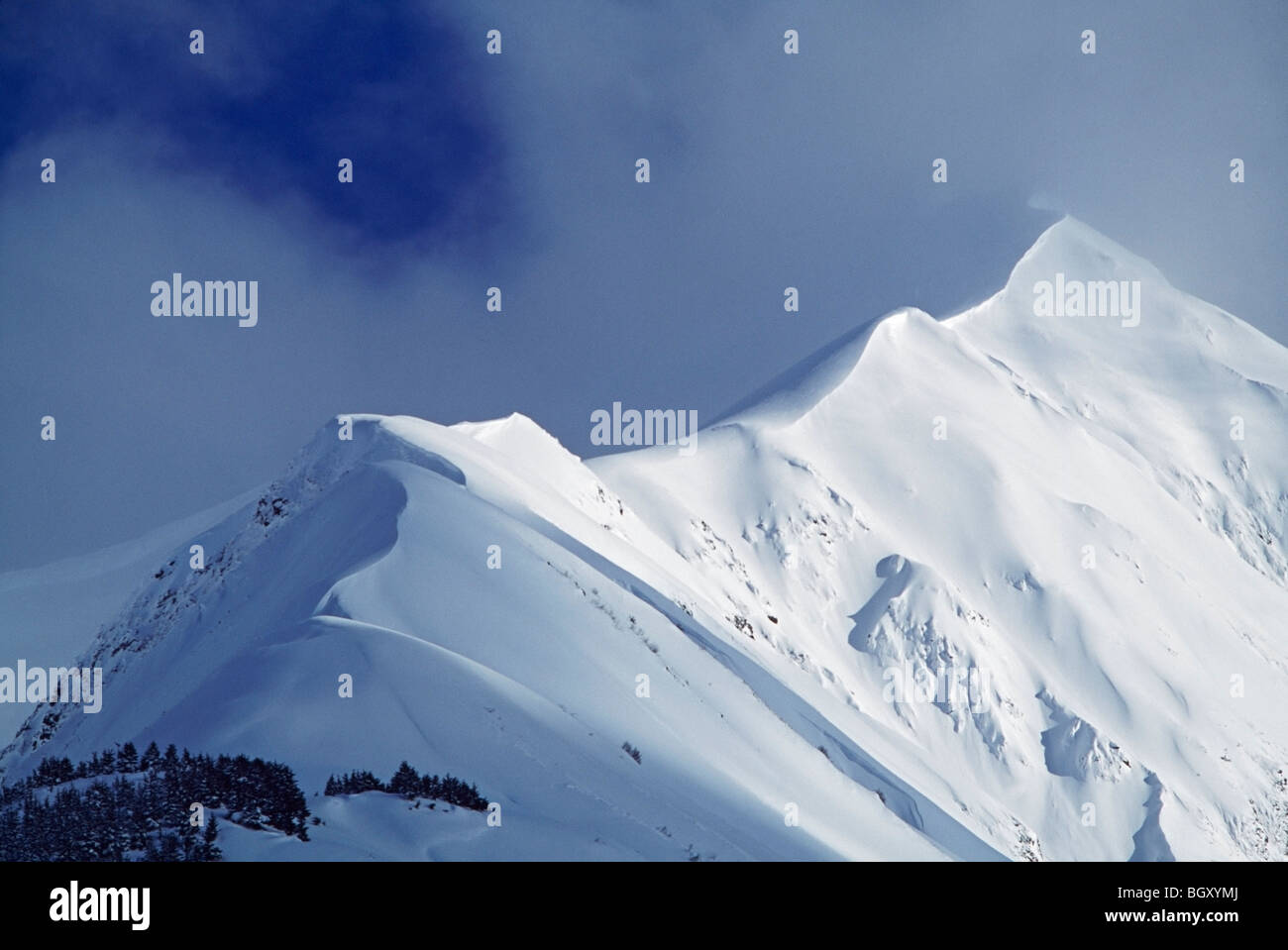 Snow cornice leading up to mountain peak Stock Photo - Alamy