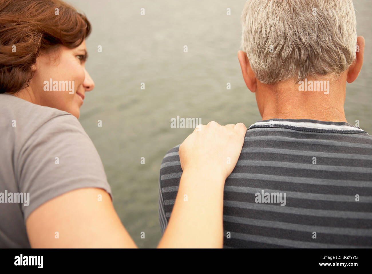 Middle aged couple, hand on shoulder Stock Photo - Alamy