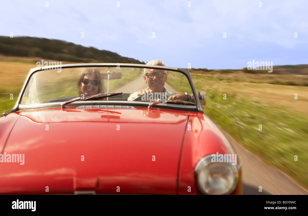 Mid aged couple in sports car Stock Photo - Alamy