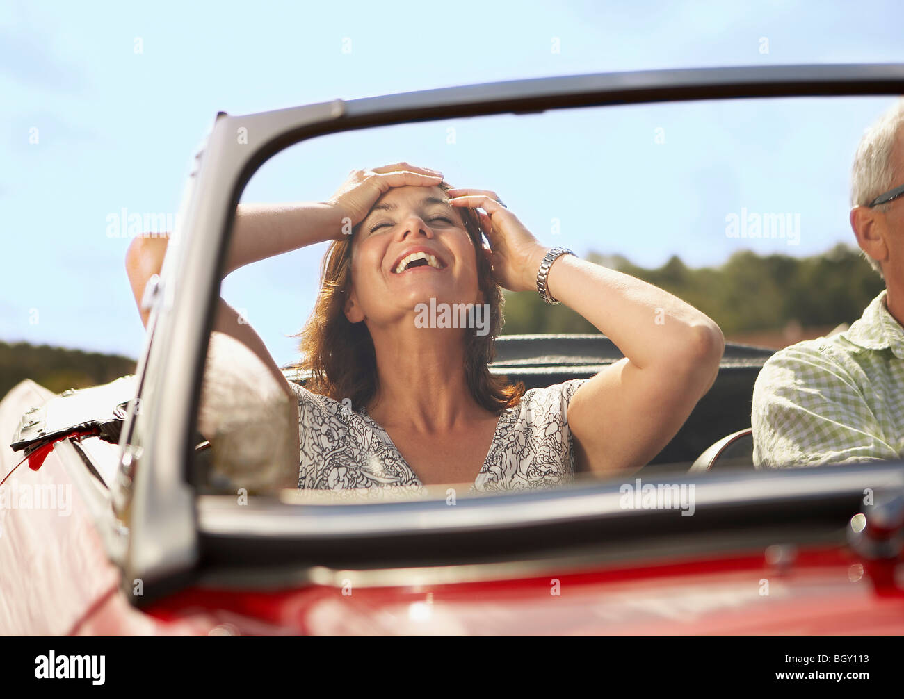 Mid aged Couple in sports car Stock Photo - Alamy