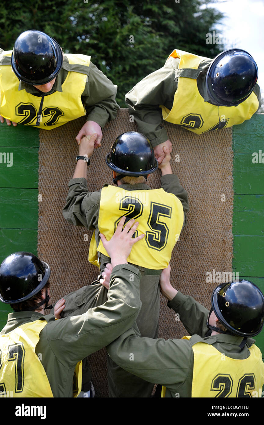 Sixteen year old boys tackle the wall during physical problem solving ...