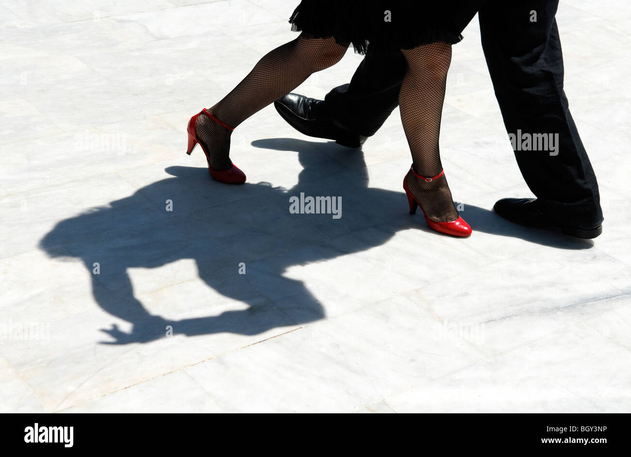 legs of a Couple dancing Tango outside on marble surface in the ...