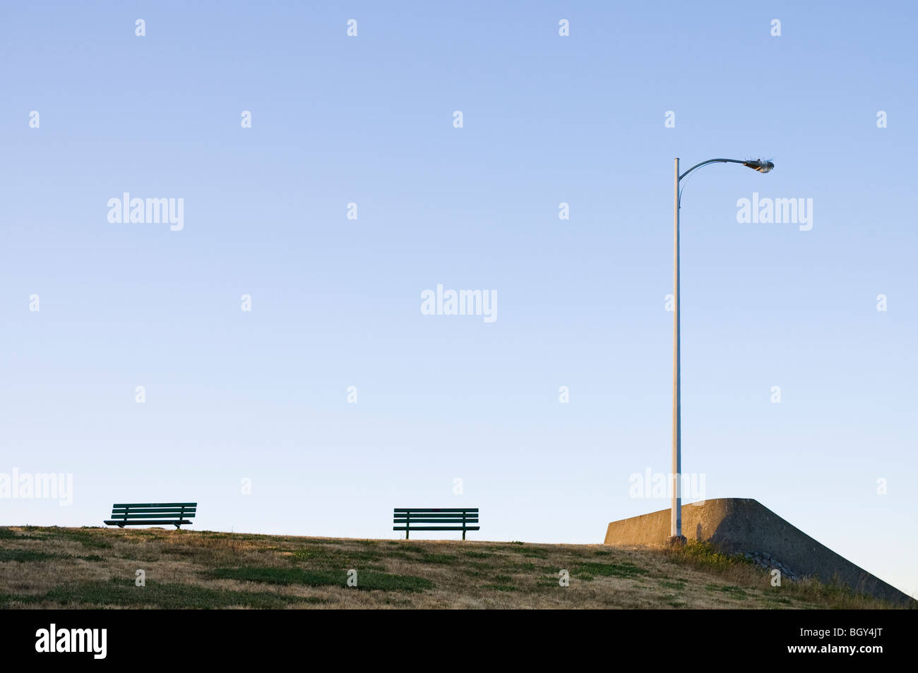 Meeting of a wall, light post and two bench at Clover point in Victoria ...