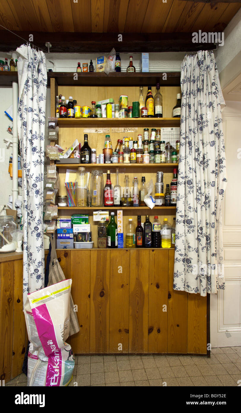 Cluttered kitchen cupboard with spices Stock Photo - Alamy