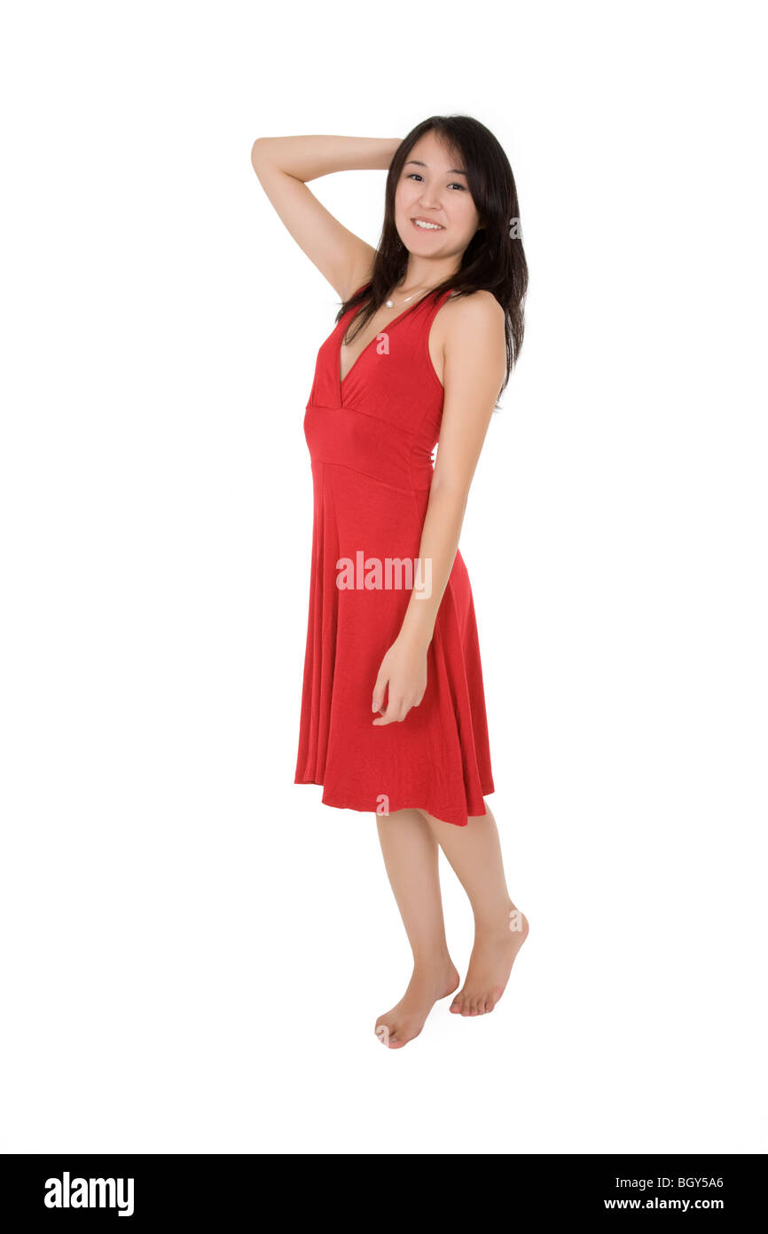 Beautiful Asian woman in a red sun dress posing on a white background ...