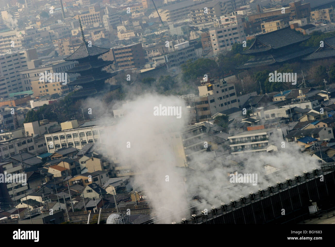 Steam rises from air conditioning units in front of Toji Temple pagoda ...