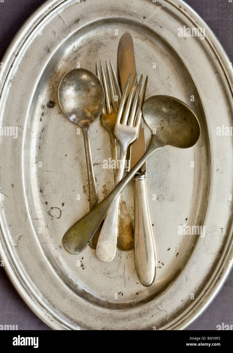 Old silver platter with silverware and ladle Stock Photo - Alamy