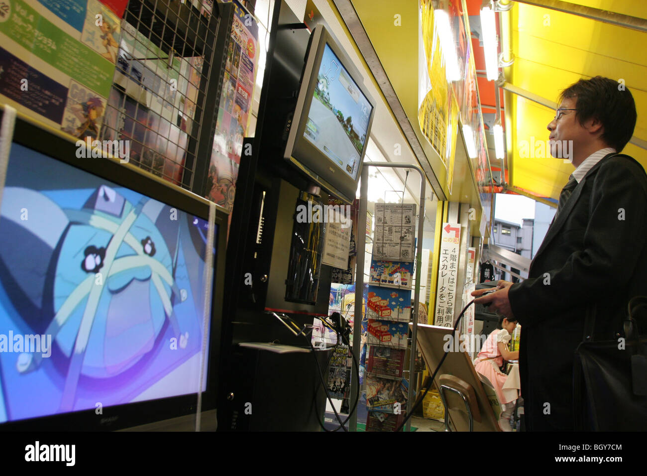 Customers try out the new PlayStation3 gaming console outside an ...