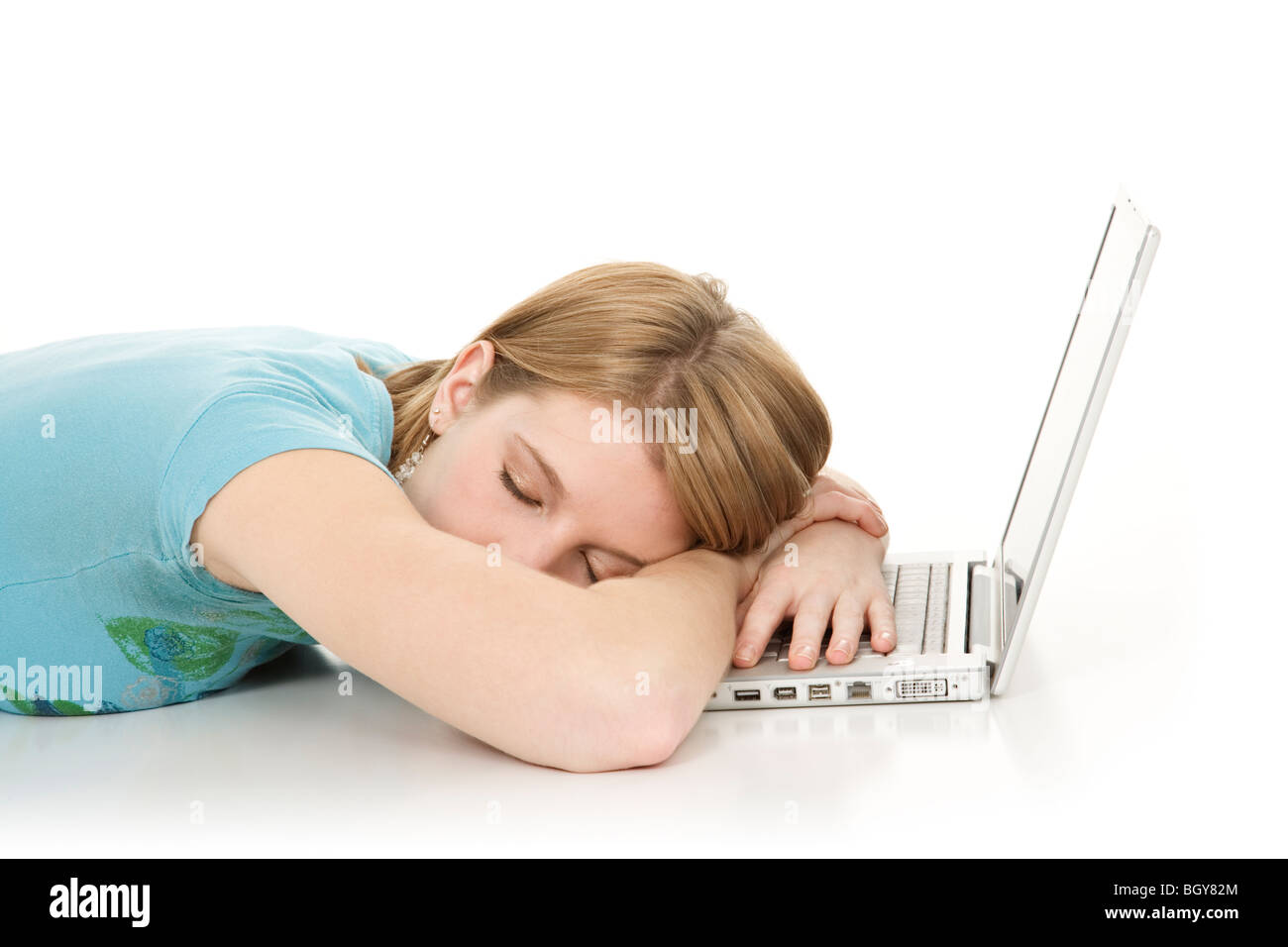 Caucasian teenager sleeping while working on a laptop computer Stock ...