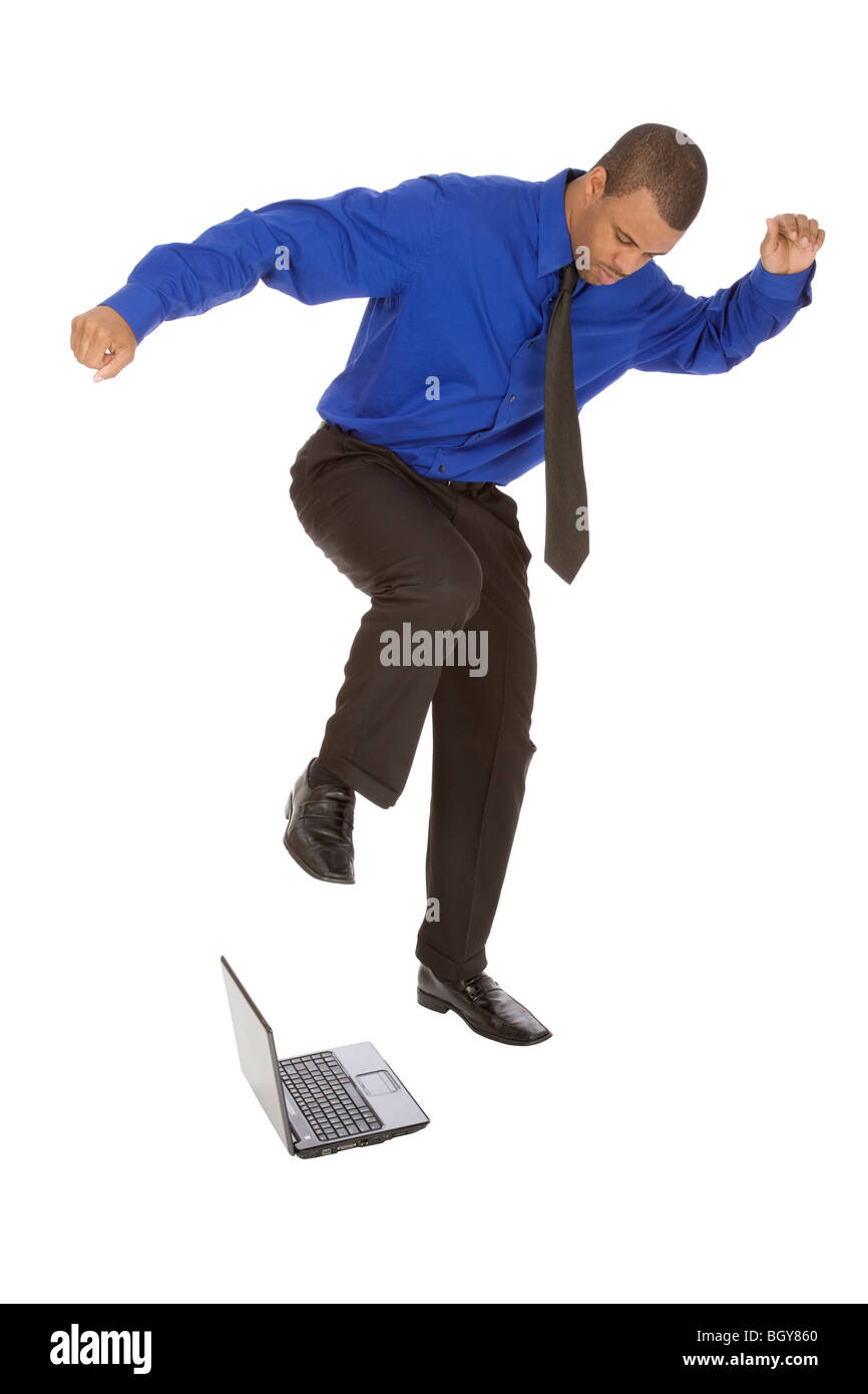 African American businessman kicking a laptop on white background Stock ...