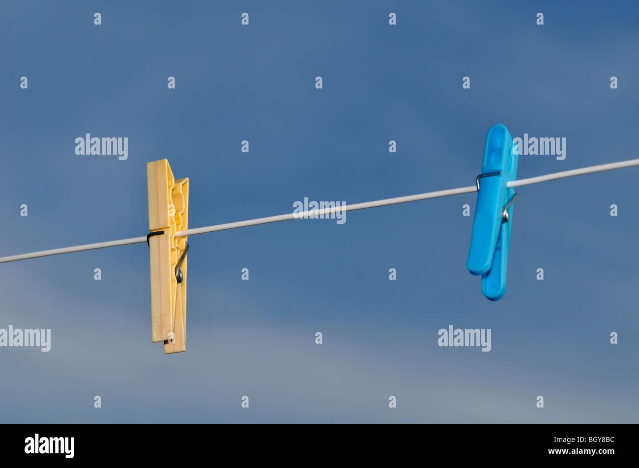 Two pegs on washing line Stock Photo - Alamy