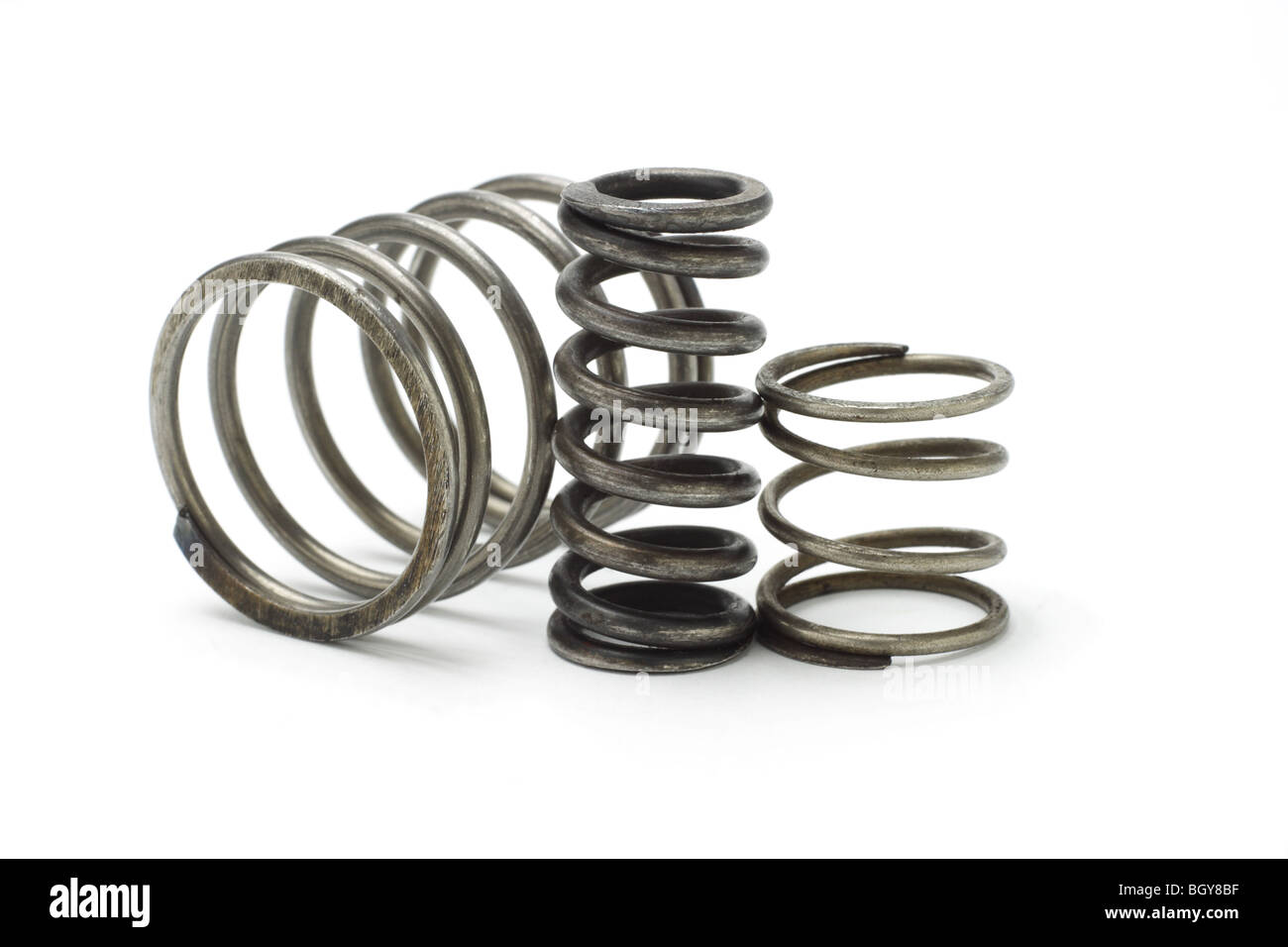 Three metal spring coils on white background Stock Photo - Alamy