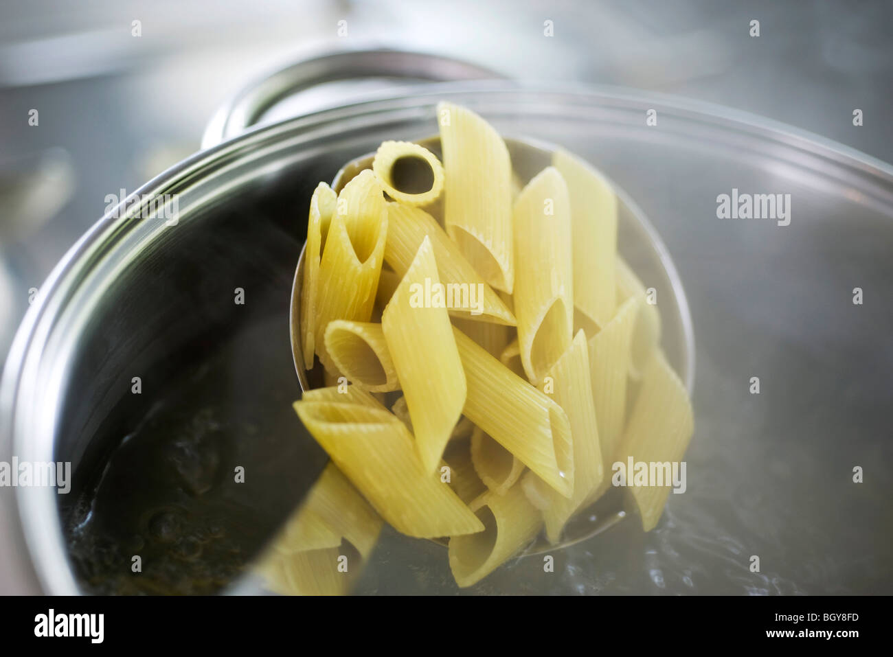 Cooking penne pasta Stock Photo - Alamy