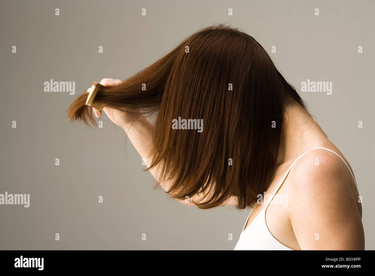 Woman combing hair Stock Photo - Alamy