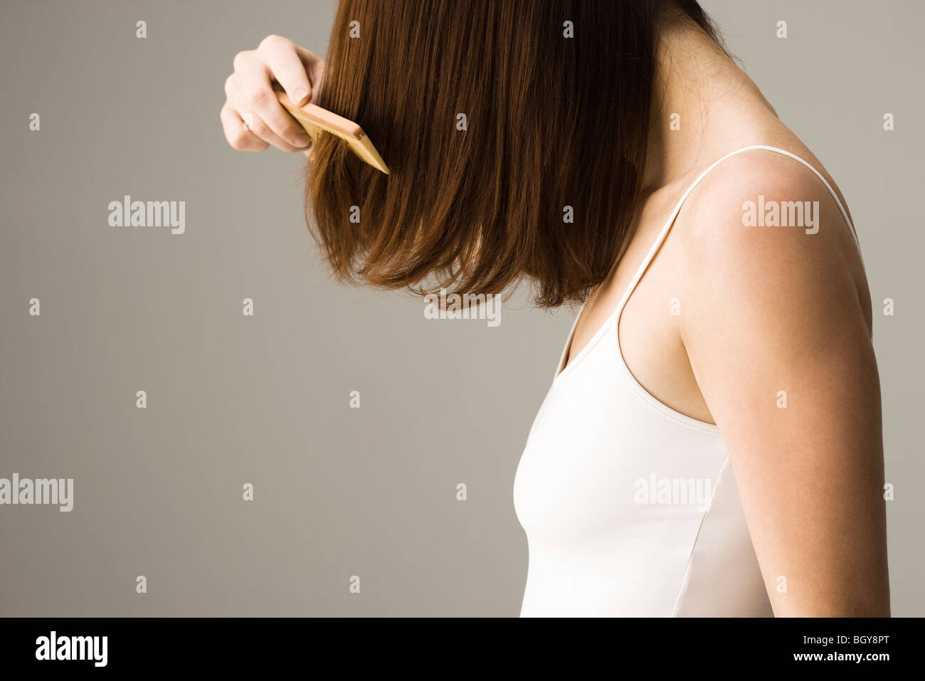Woman combing hair Stock Photo - Alamy