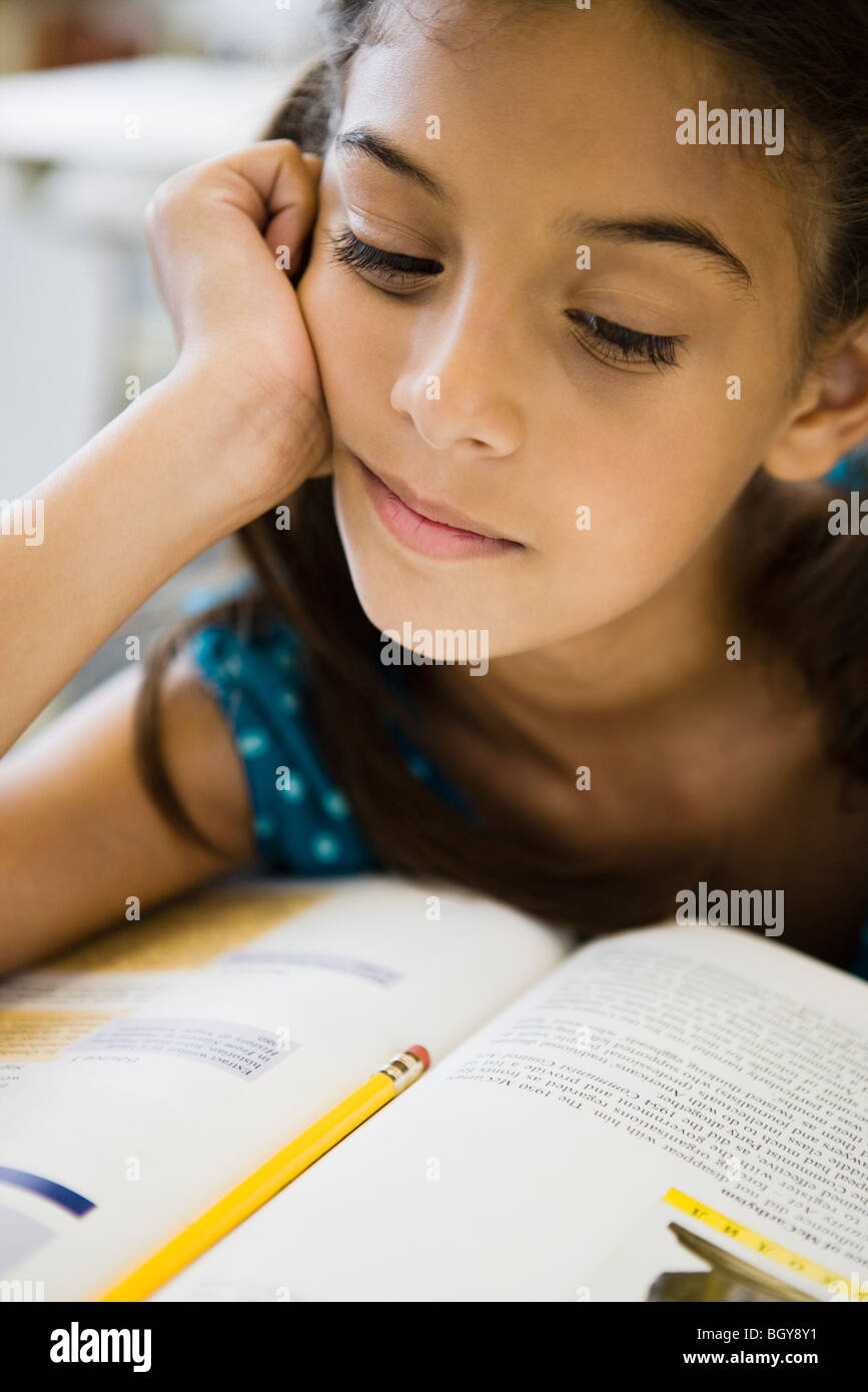 Elementary school student studying textbook Stock Photo - Alamy