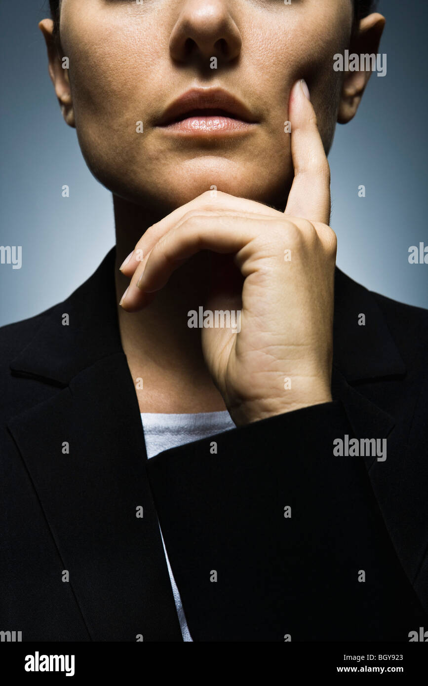 Businesswoman with hand held under chin deep in thought, portrait Stock ...