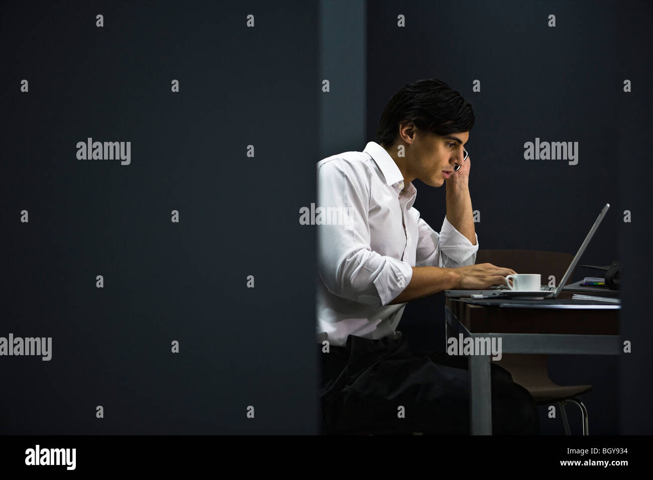Man in office working late Stock Photo - Alamy
