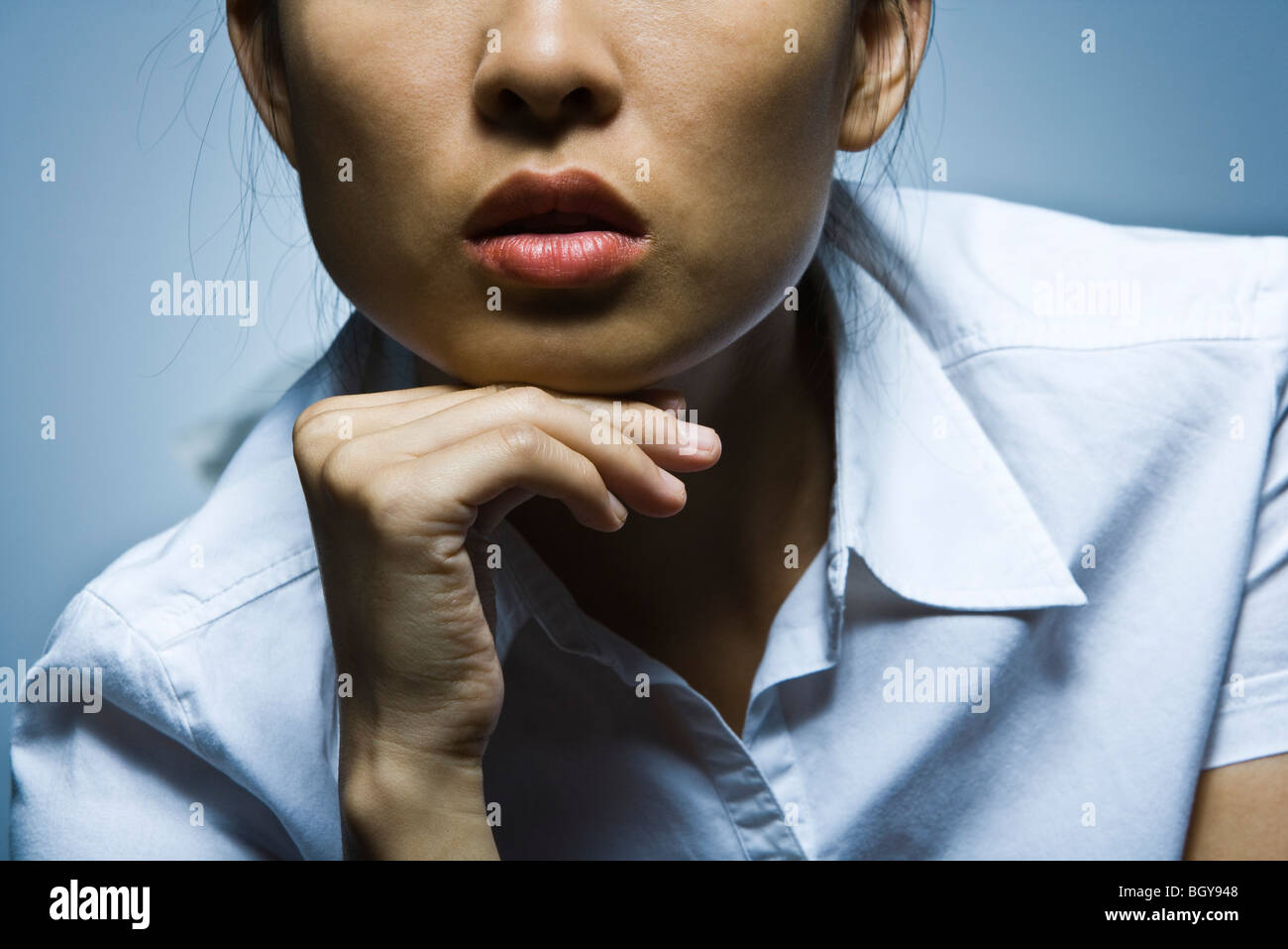 Woman with hand under chin, close-up Stock Photo - Alamy
