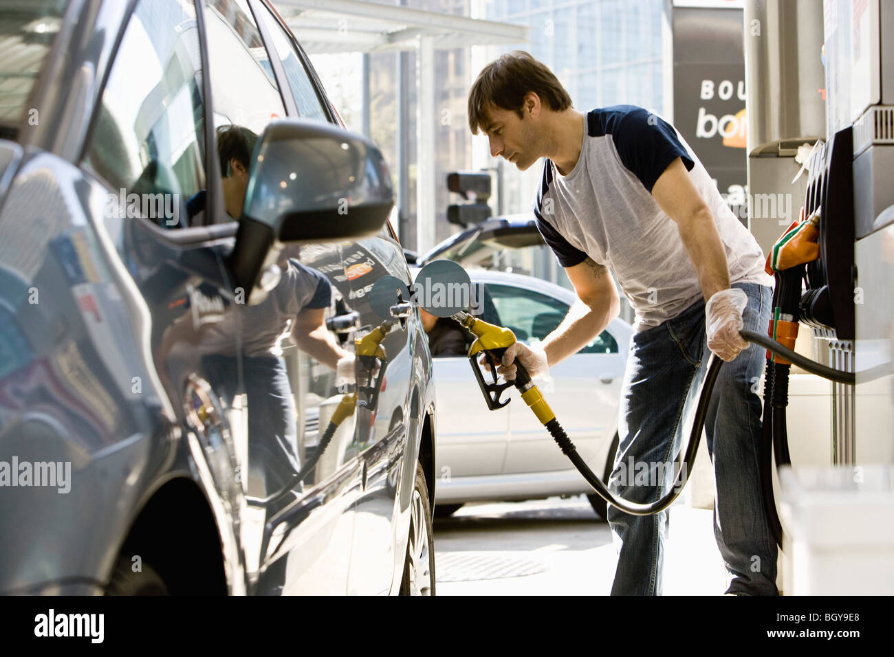 Man refueling vehicle at gas station Stock Photo - Alamy