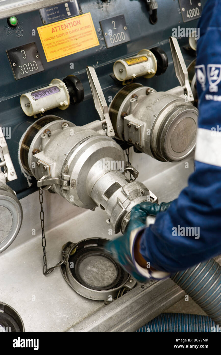 Connecting hoses to fuel tanker outlets Stock Photo - Alamy