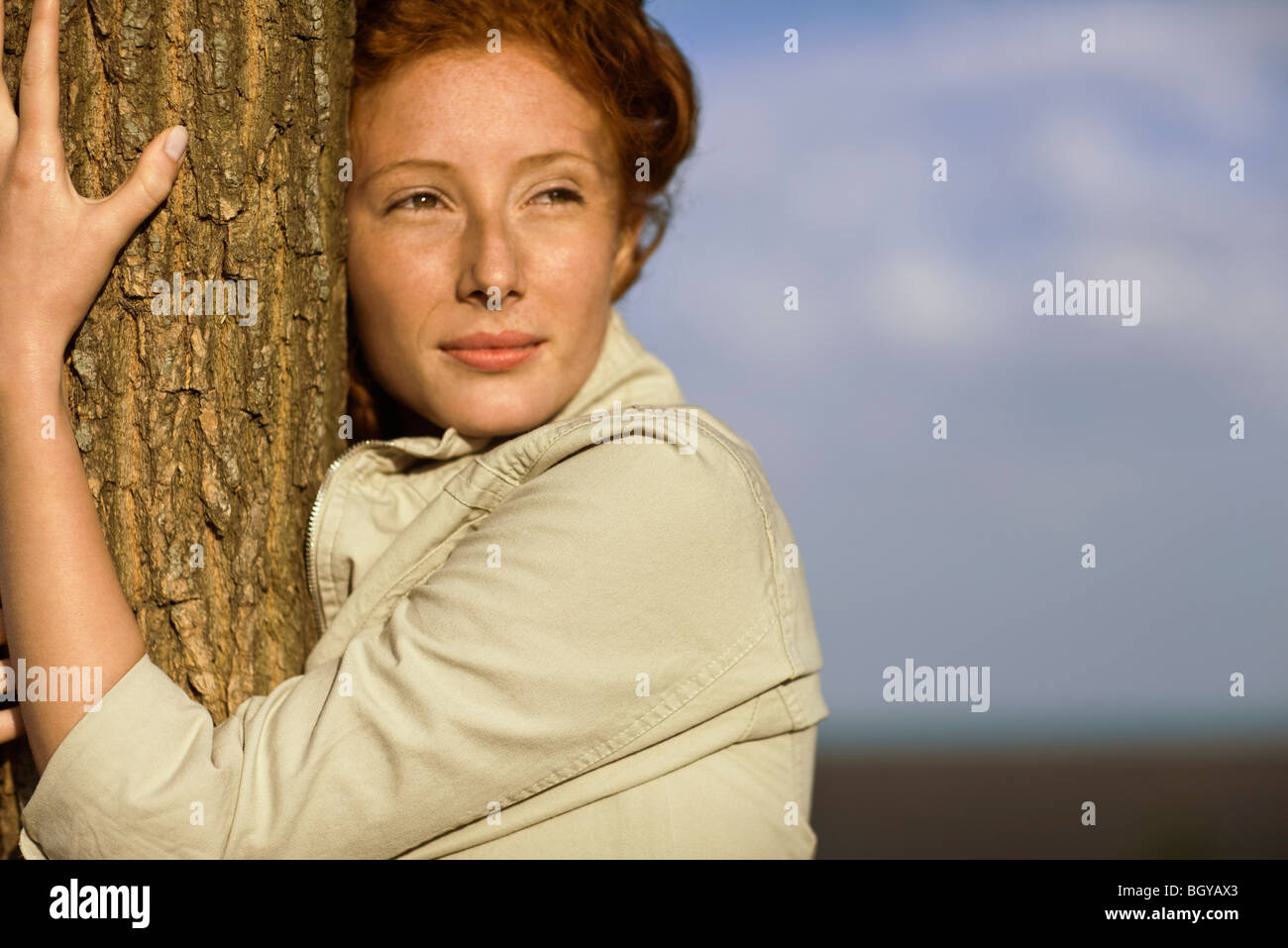 Young woman embracing tree trunk hi-res stock photography and images ...