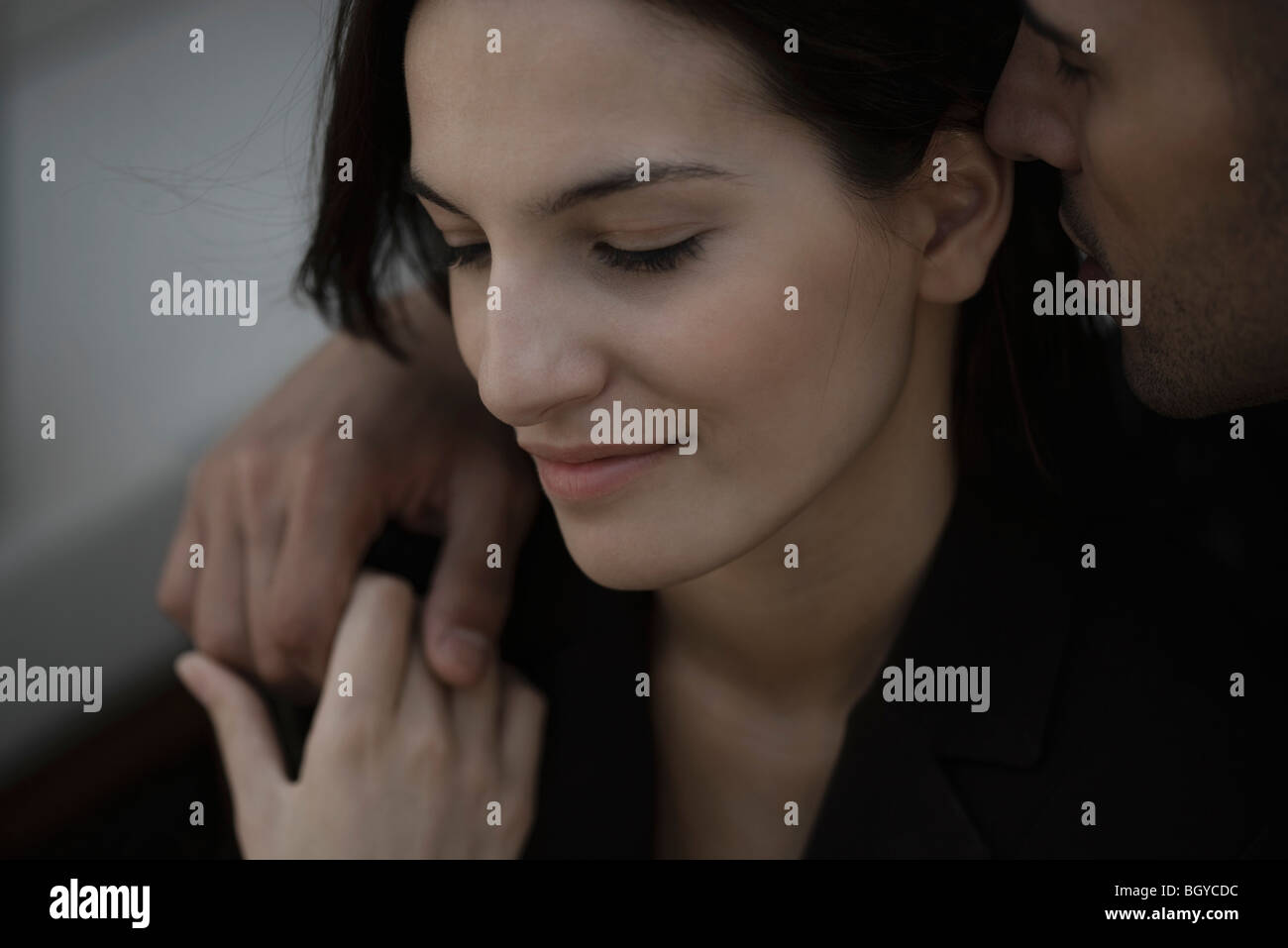 Couple, man whispering in woman's ear Stock Photo - Alamy