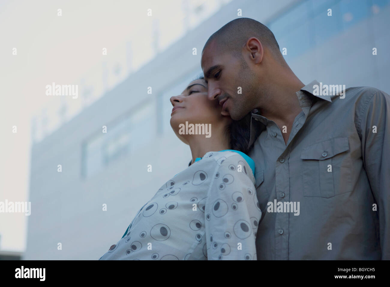 Couple cheek to cheek, woman leaning back against man Stock Photo - Alamy