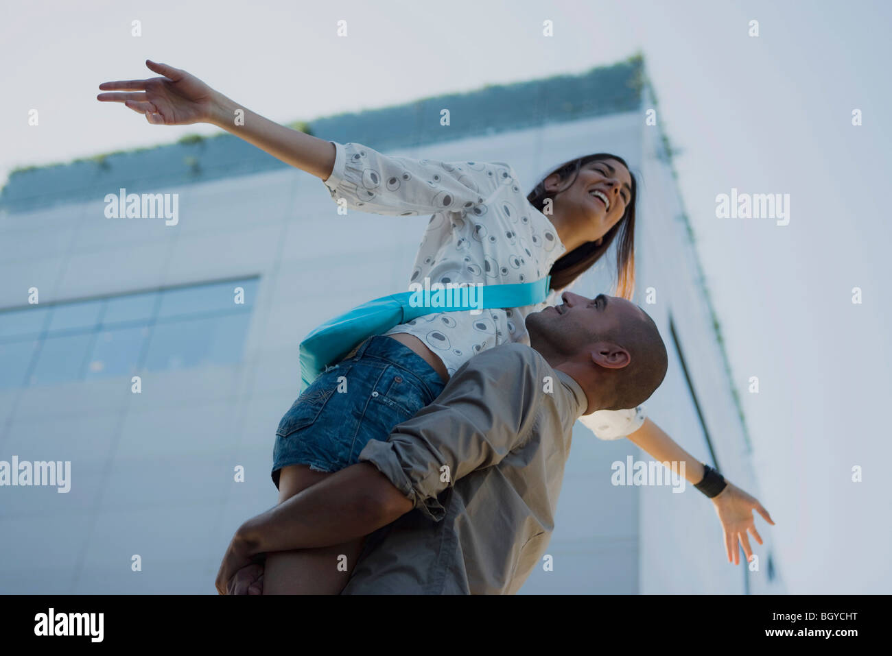 Man lifting woman in air, woman's arms outstretched Stock Photo - Alamy