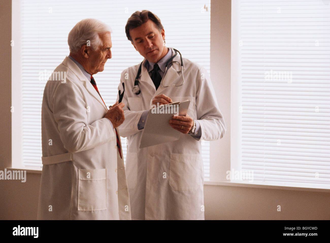 Two doctors looking at chart Stock Photo - Alamy