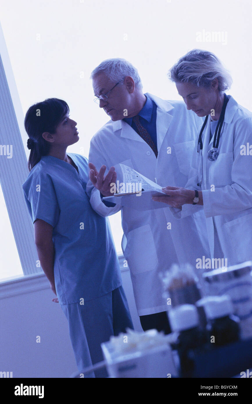 Medical team looking at chart Stock Photo - Alamy