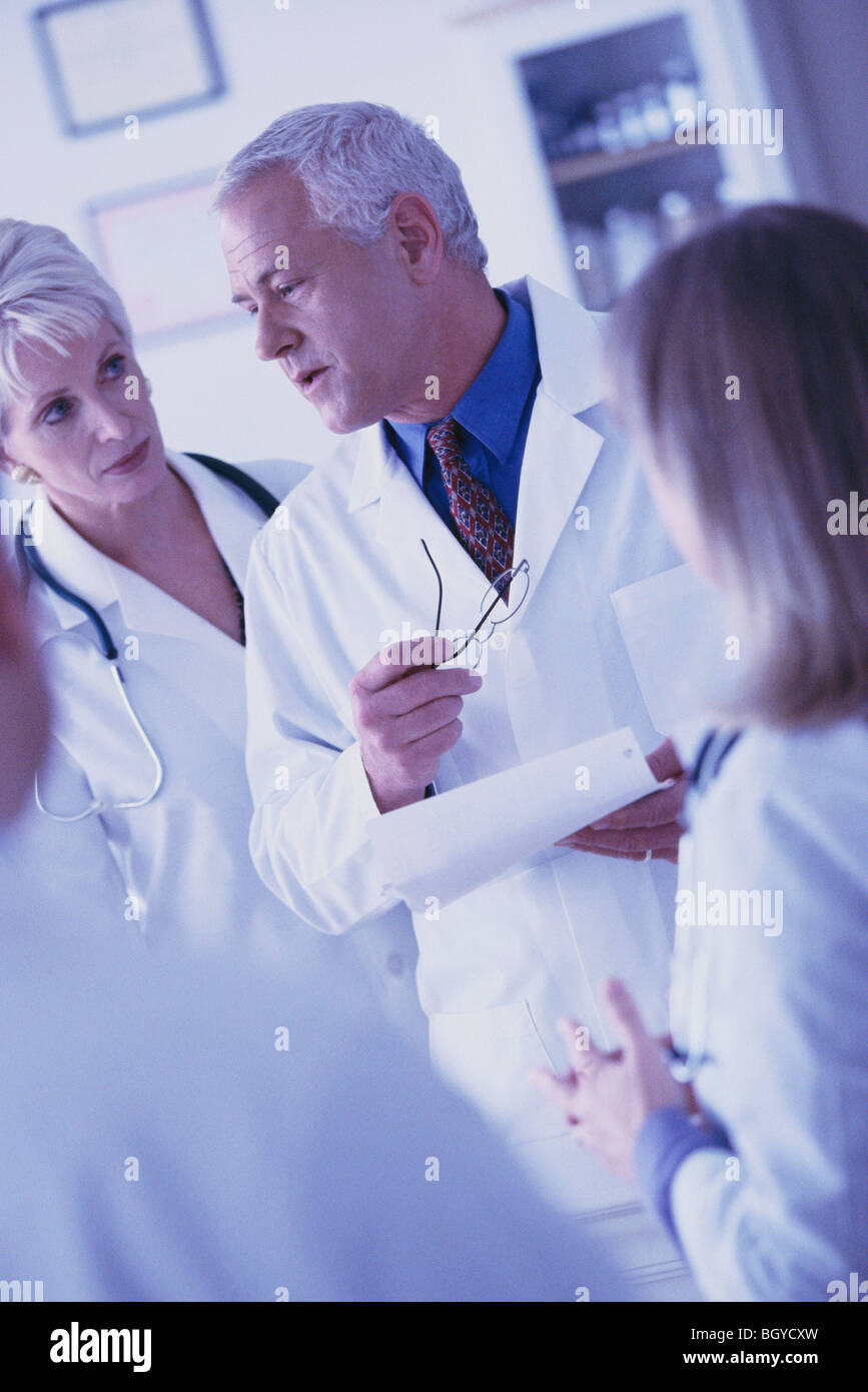 Medical team looking at chart Stock Photo - Alamy