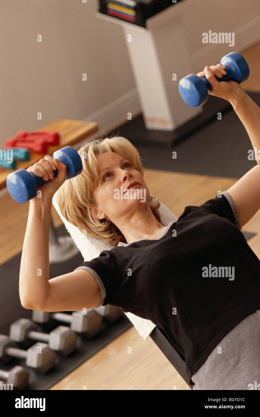 Woman lifting weights Stock Photo - Alamy