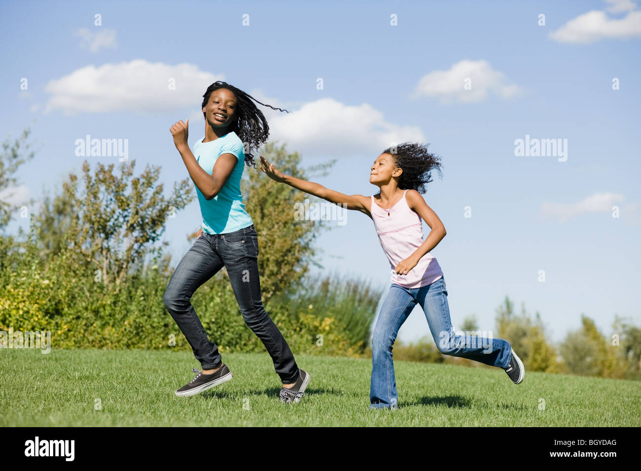Woman and girl running Stock Photo - Alamy