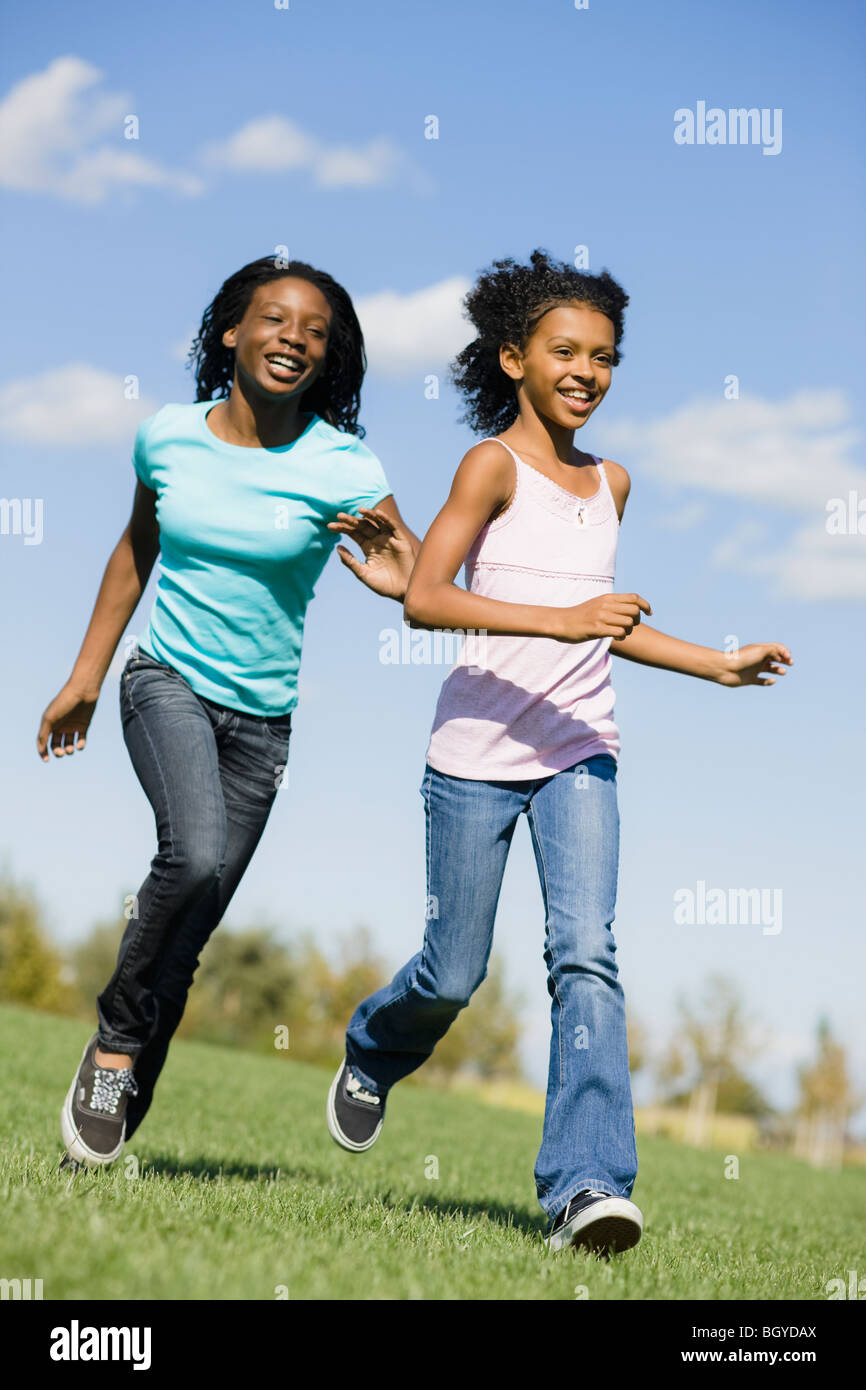 Two girls running Stock Photo - Alamy