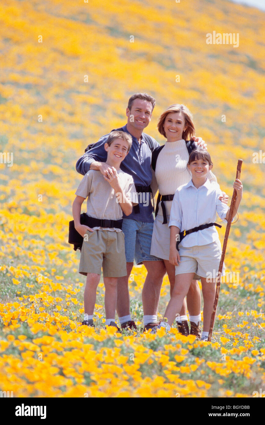 Family hiking in field of wildflowers Stock Photo - Alamy