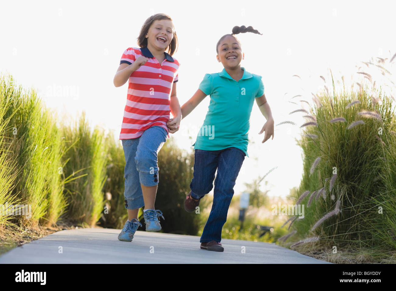 Two girls running hi-res stock photography and images - Alamy