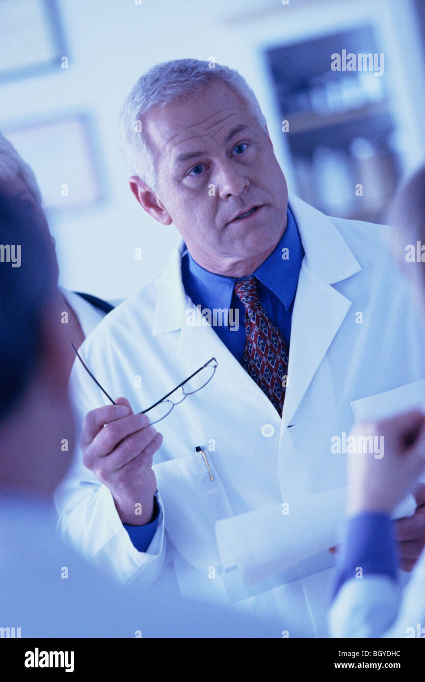 Doctor giving patient documents hi-res stock photography and images - Alamy