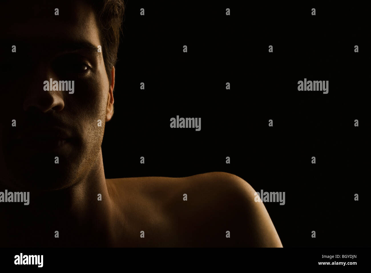 Man, bare-chested, looking at camera, cropped Stock Photo - Alamy