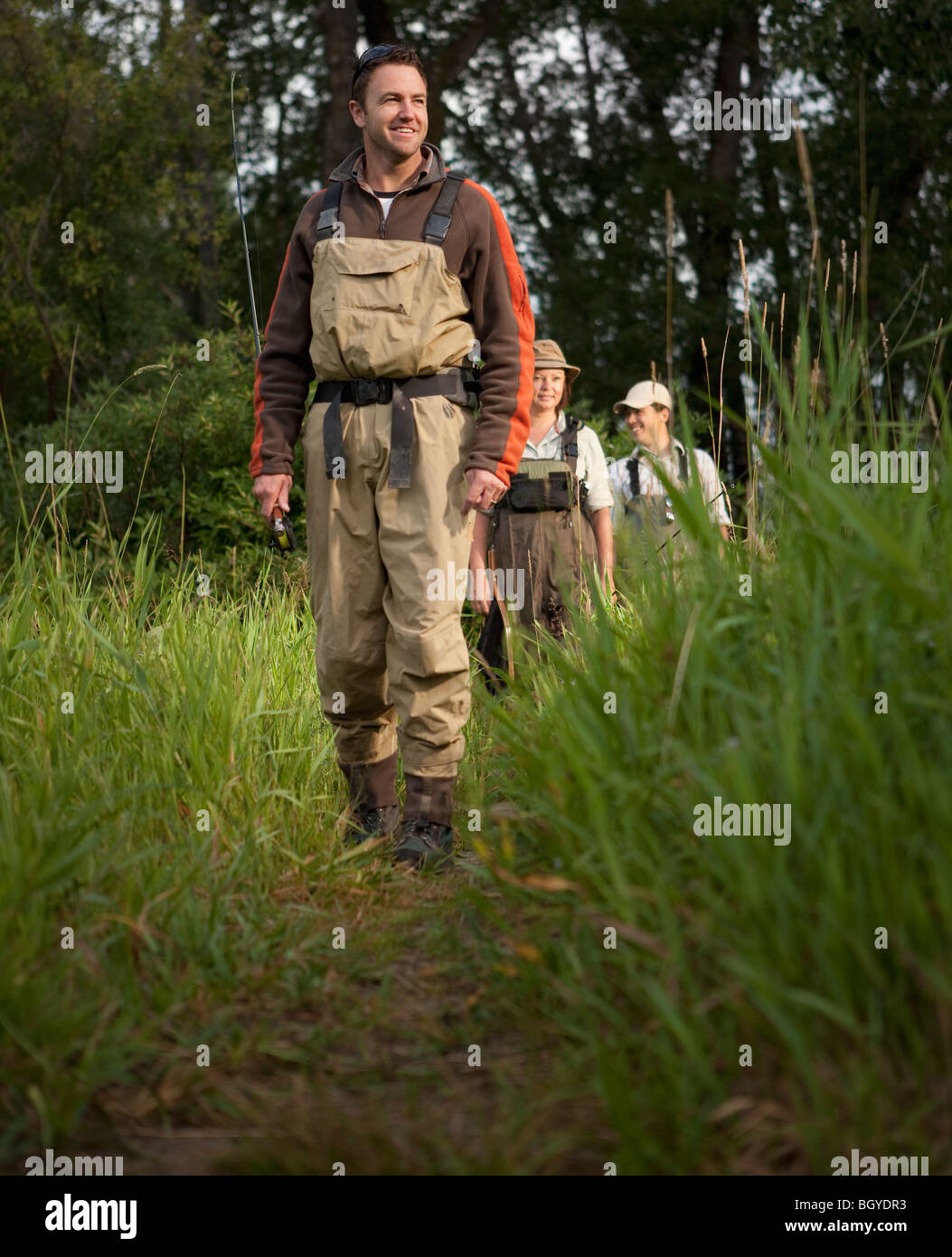 Fly Fisherman walking on path Stock Photo - Alamy