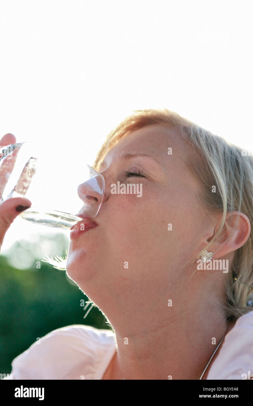 Young woman drinking Stock Photo - Alamy