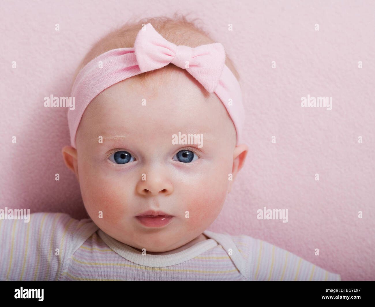 Portrait of baby girl with pink ribbon Stock Photo - Alamy