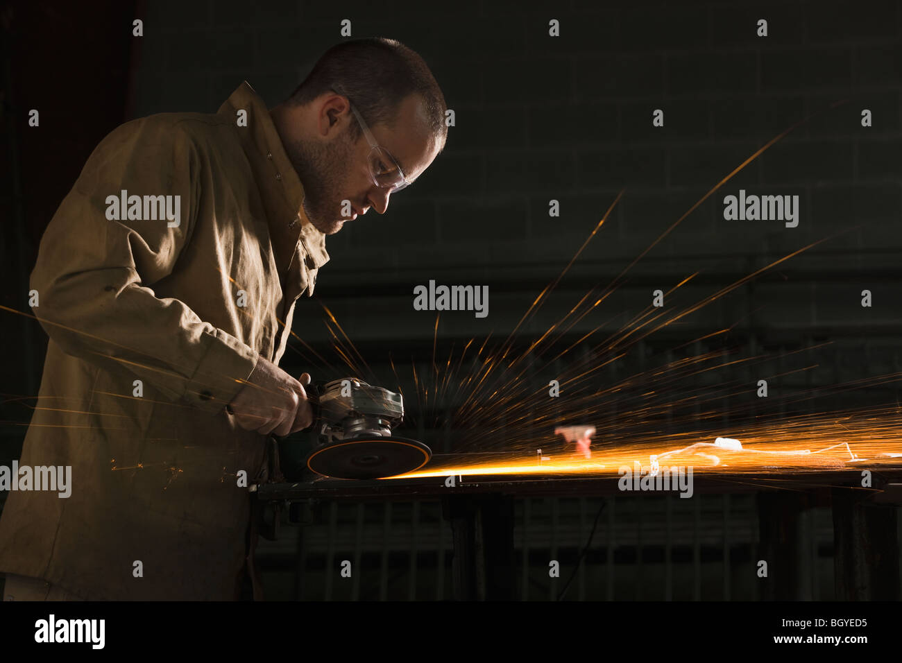 Steel grinder working in metal shop Stock Photo - Alamy